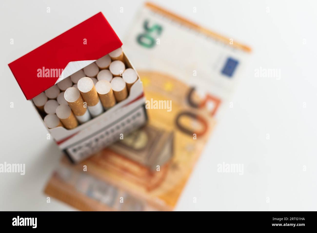 Euros Money notes one hundred and cigarettes box on white background ...