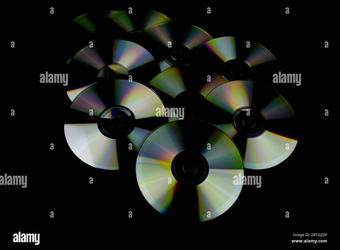 CD and DVD isolated on black background with colorful light reflections ...