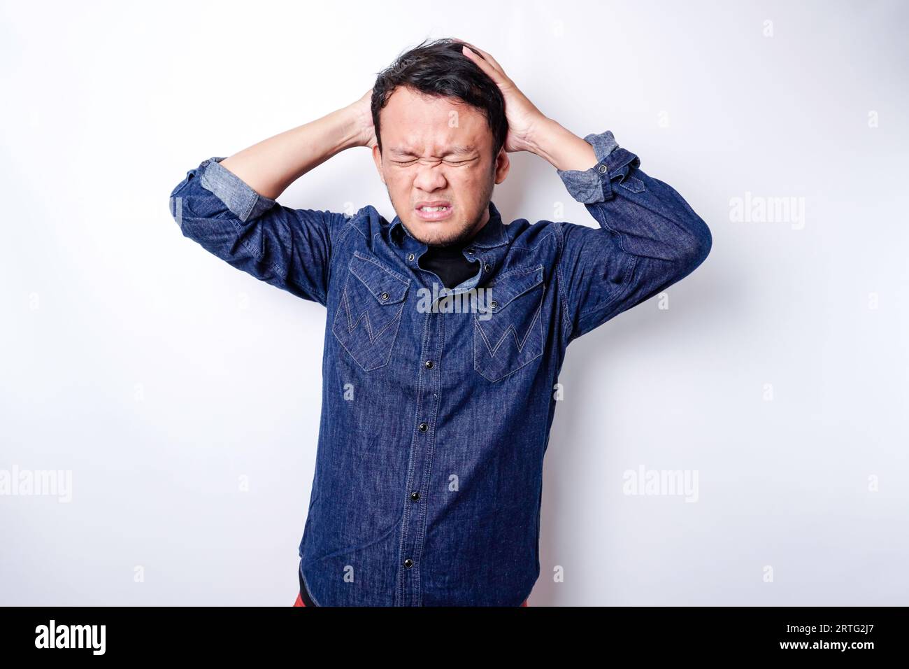 A portrait of an Asian man wearing a blue shirt isolated by white ...