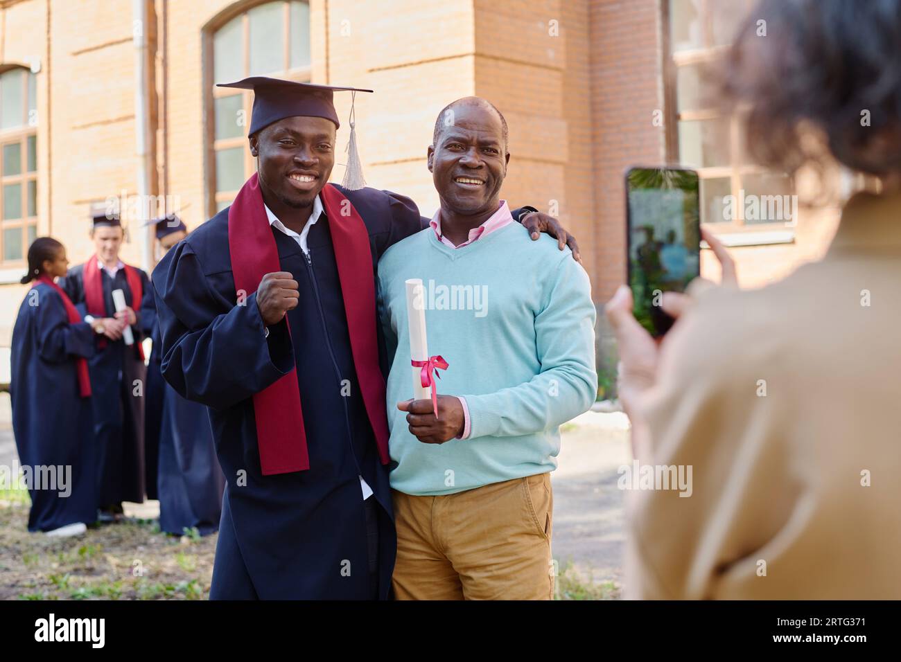 African American graduated student making photo with his family ...