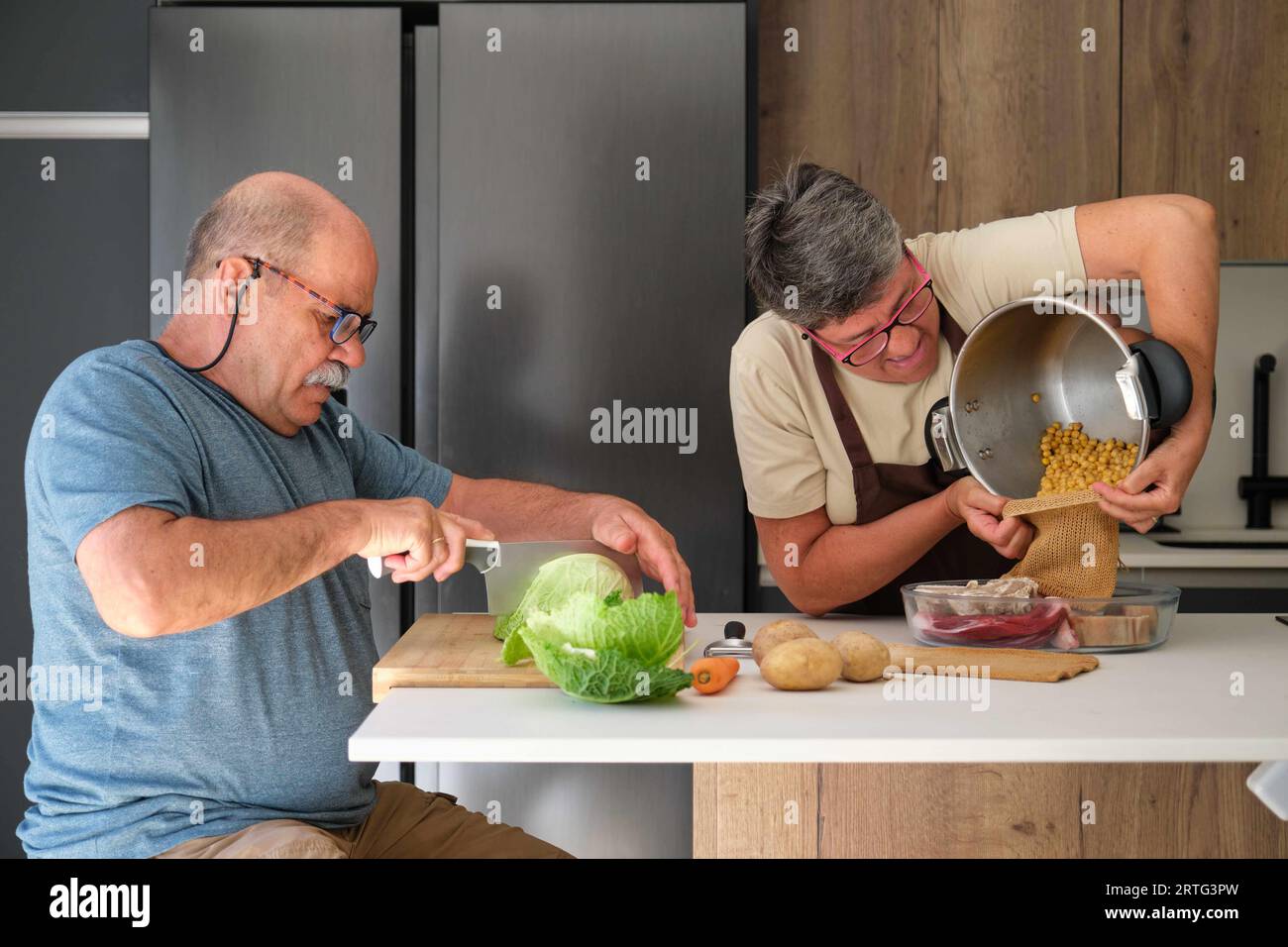 Mature Spanish couple cooking cocido, typical Spanish dish Stock Photo ...