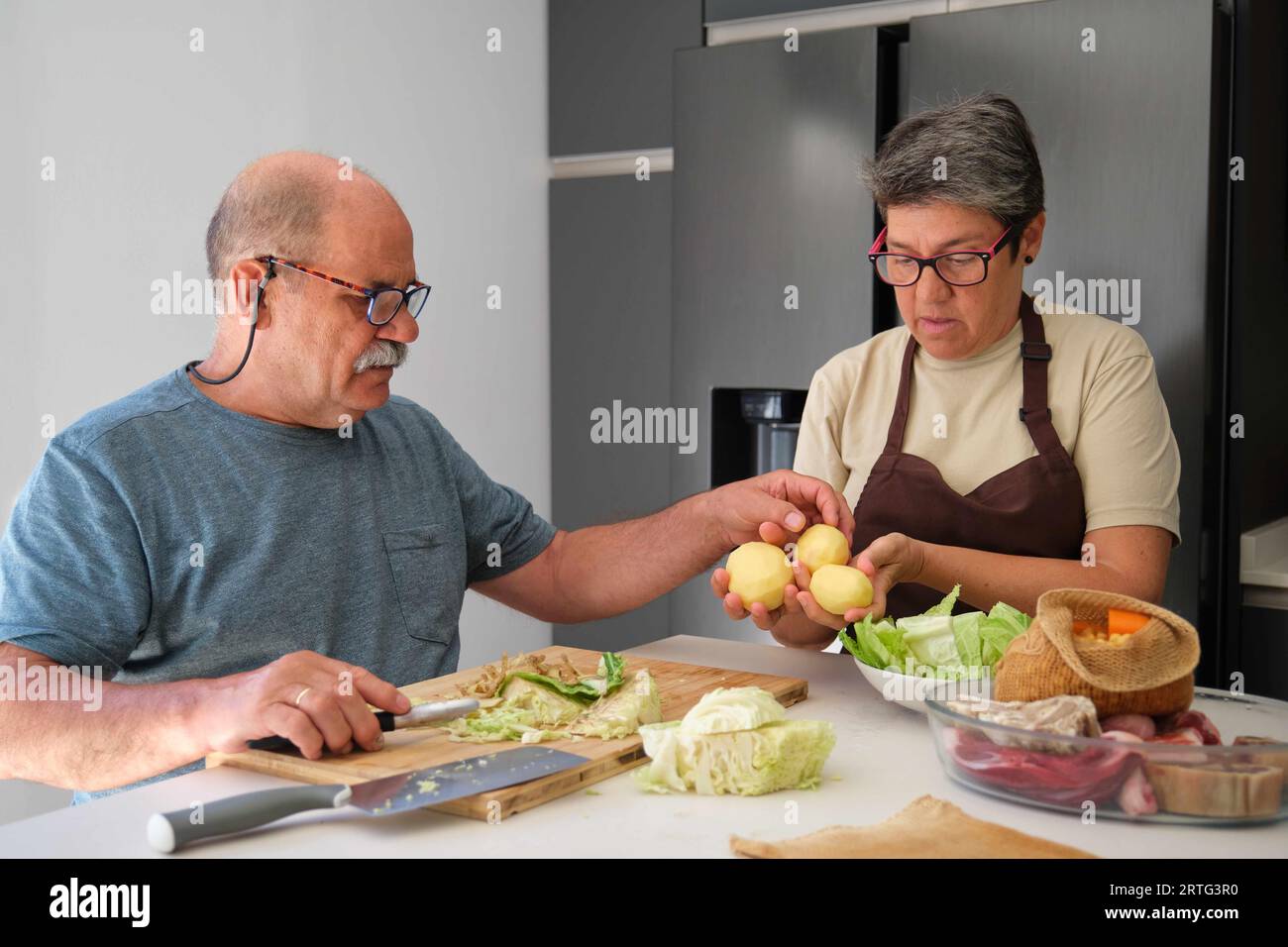 Mature Spanish couple cooking cocido, typical Spanish dish Stock Photo ...