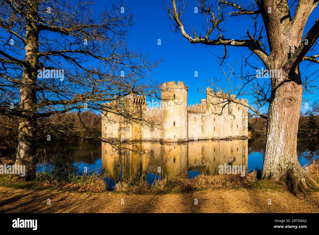 Reflections in the moat on a sunny winter's day at Bodiam Castle ...