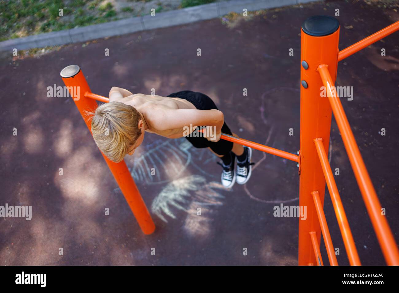 A teenager stretched out holding onto his arms and performing acrobatic ...