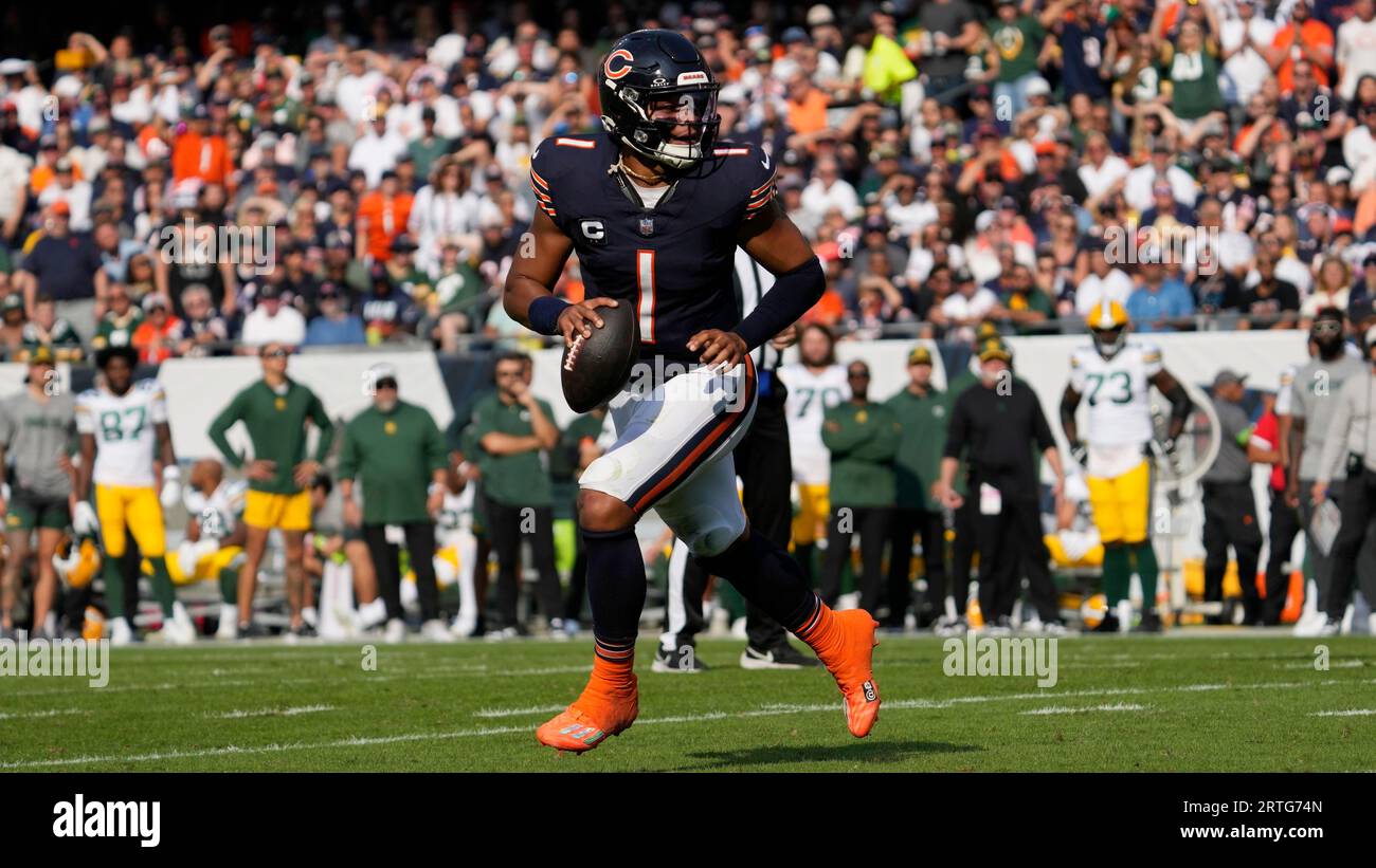 Chicago Bears quarterback Justin Fields runs as he looks to pass during ...