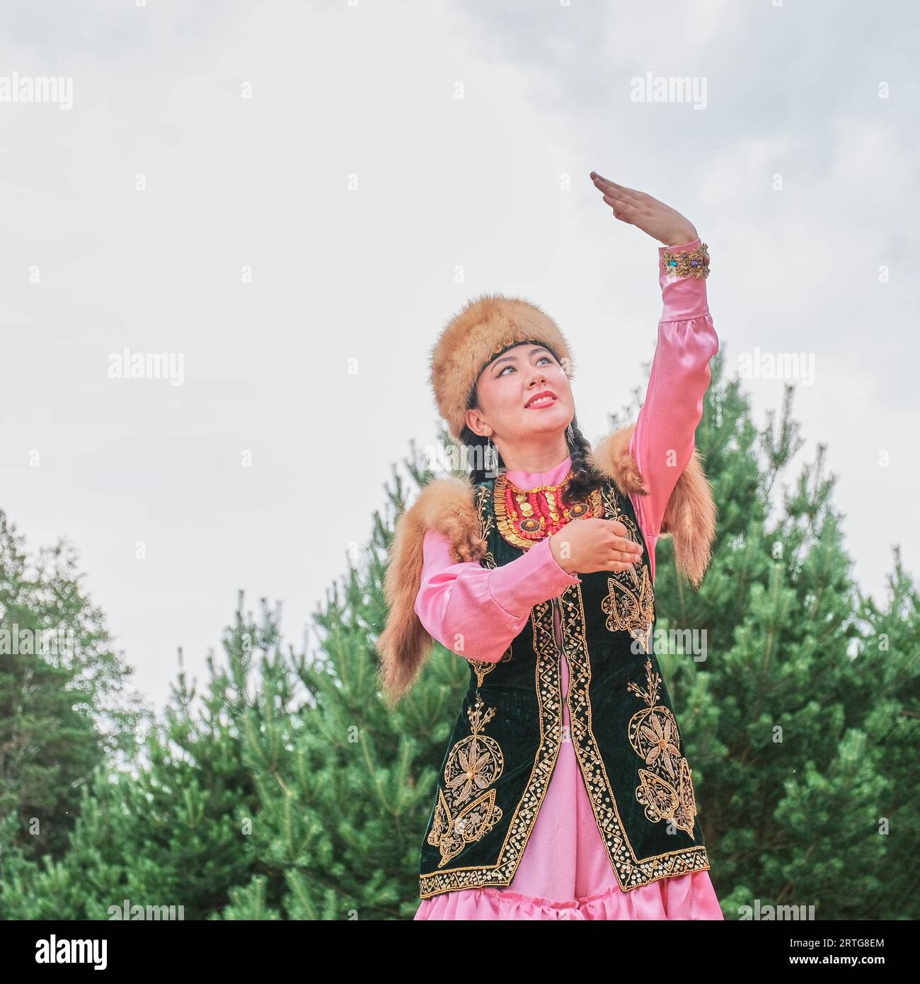 Close up of attractive smiling Asian girl in fur headdress and ...