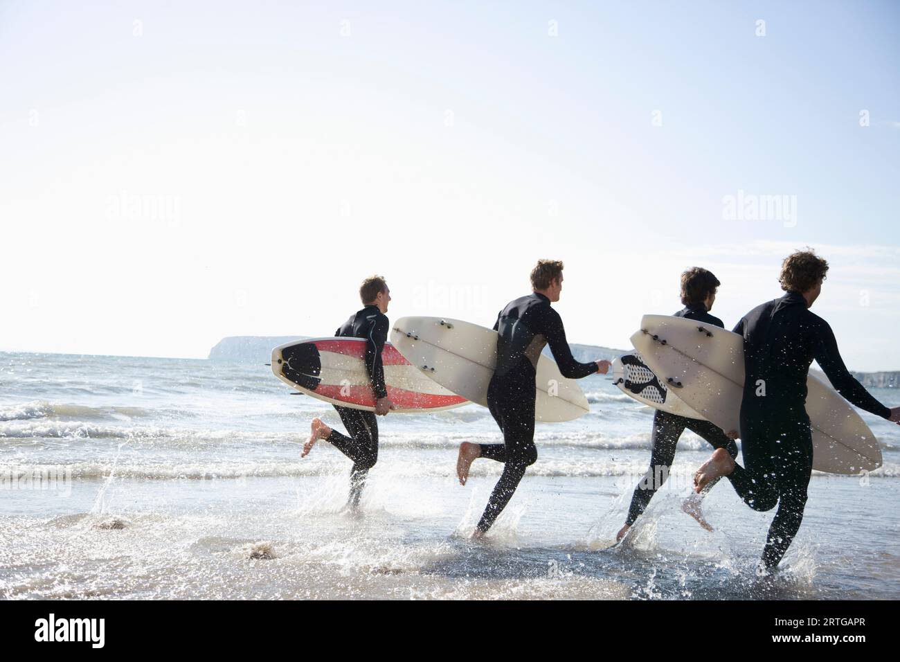 Rear young man running beach hi-res stock photography and images - Alamy