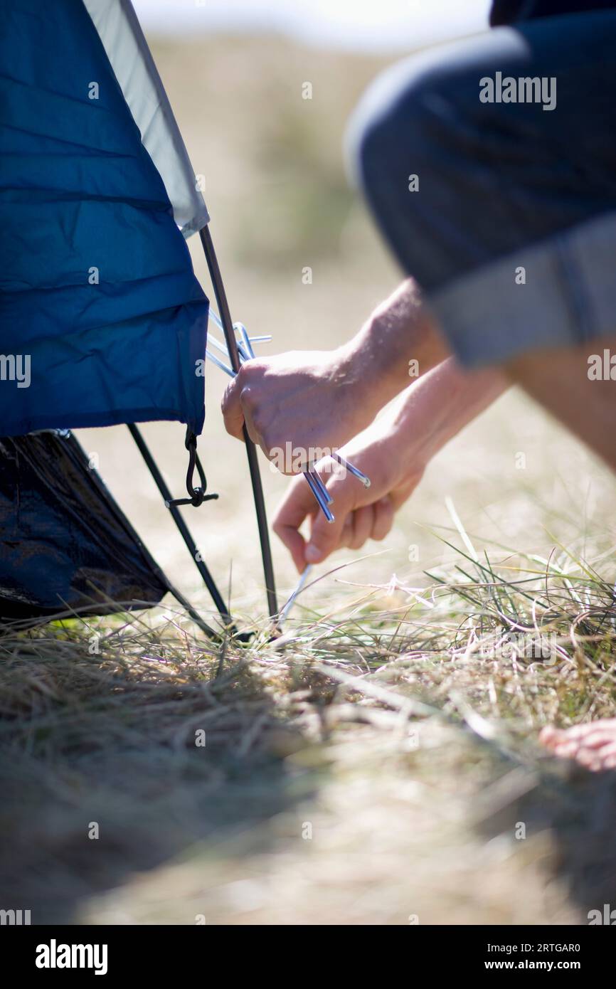 Camper hands fixing tent pole Stock Photo - Alamy