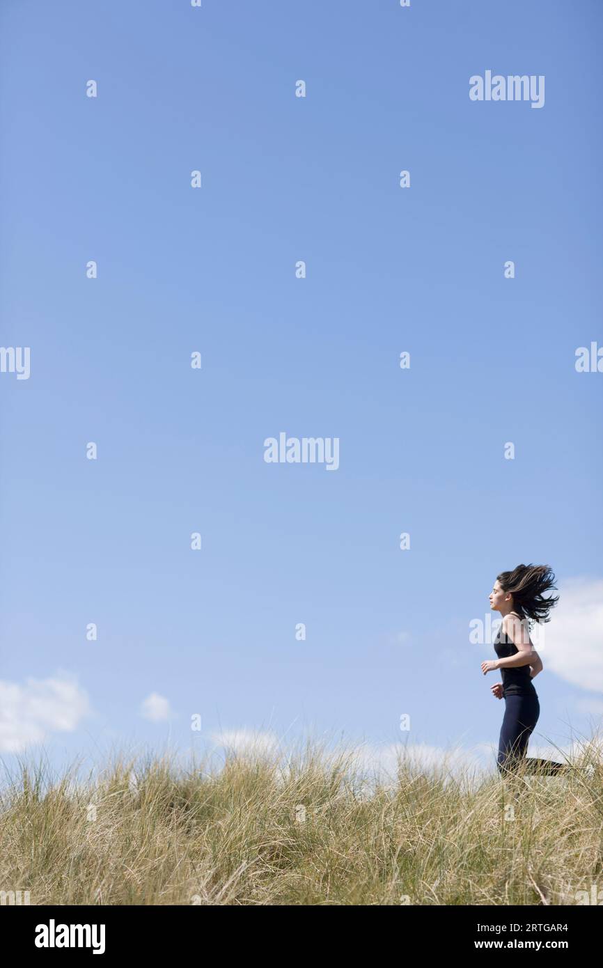 Vertical athletic fitness woman running hi-res stock photography and ...