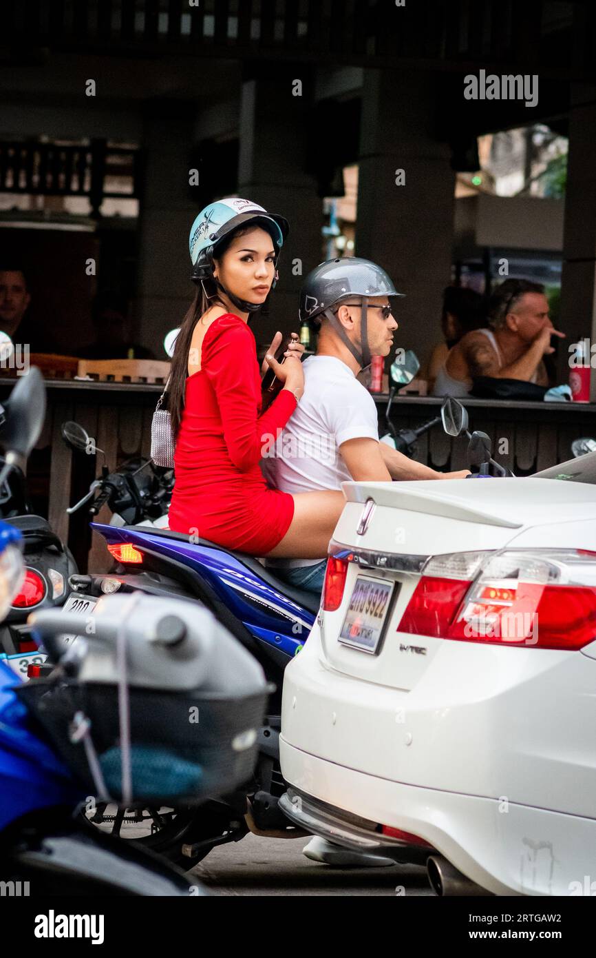 Local Thai people, tourists and residents rush past the busy junction ...