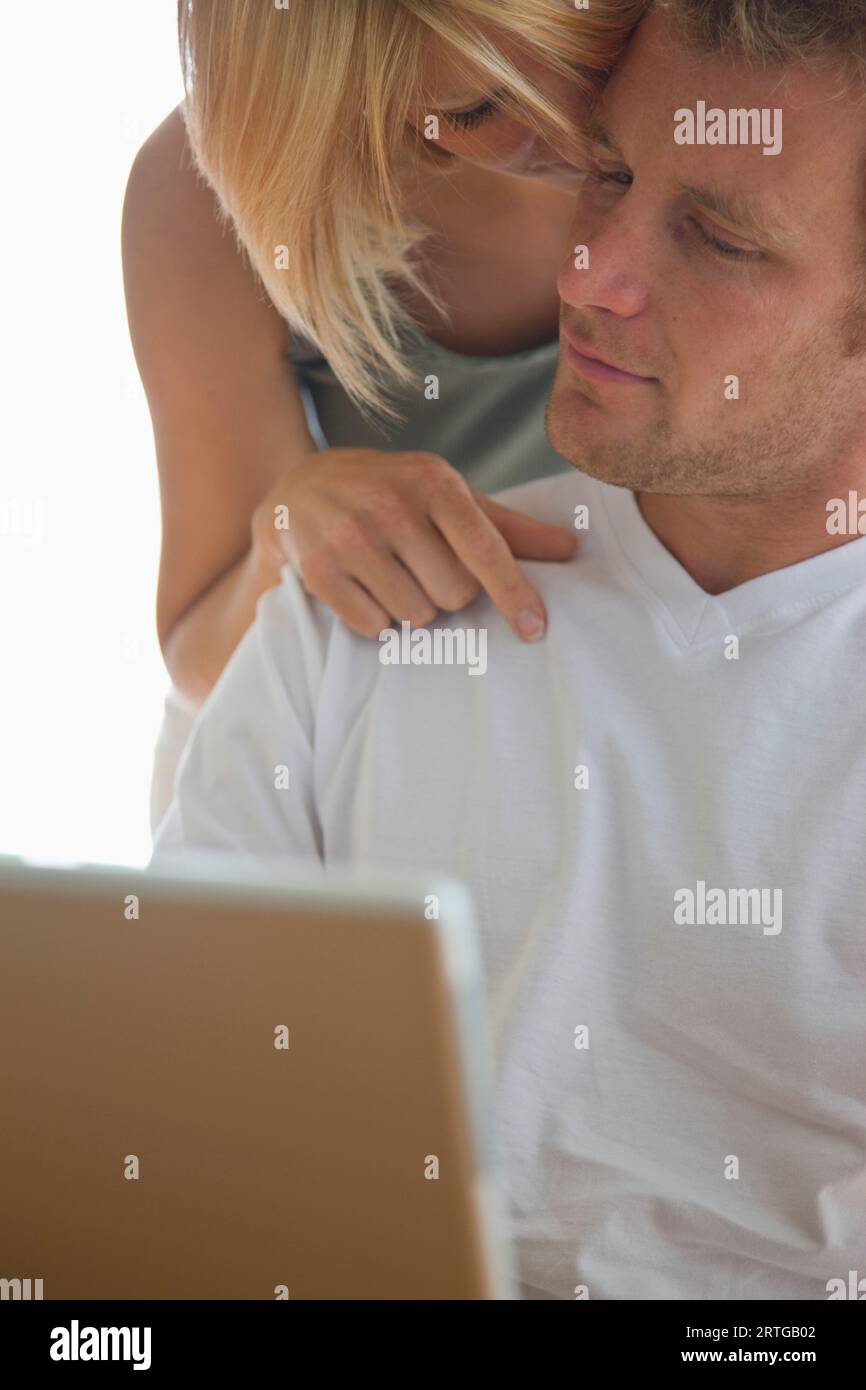 Young couple in front of laptop computer Stock Photo - Alamy