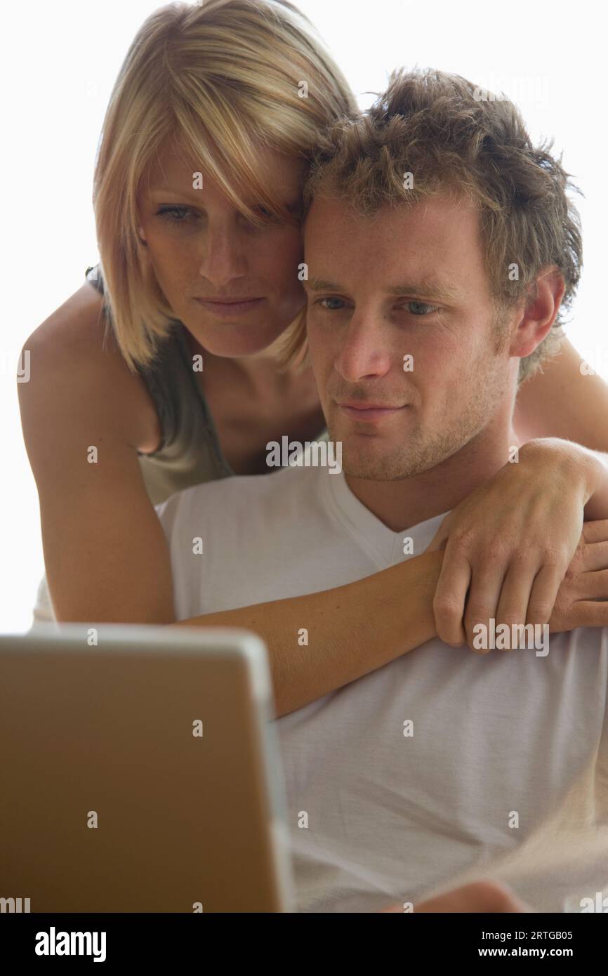 Adult looking at computer screen behind hi-res stock photography and ...
