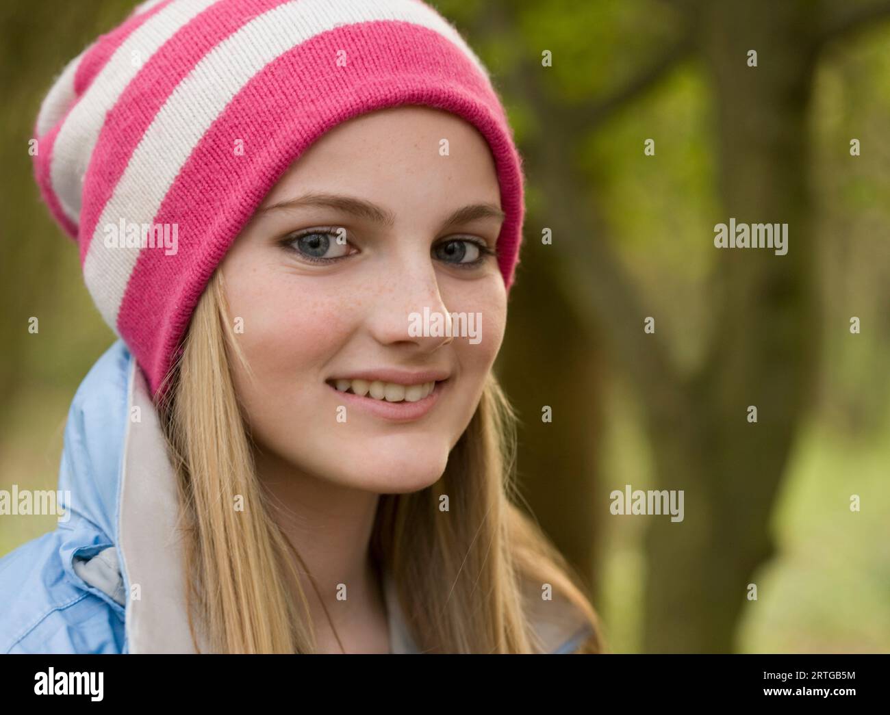 Close up of teenaged girl wearing woolly hat Stock Photo - Alamy