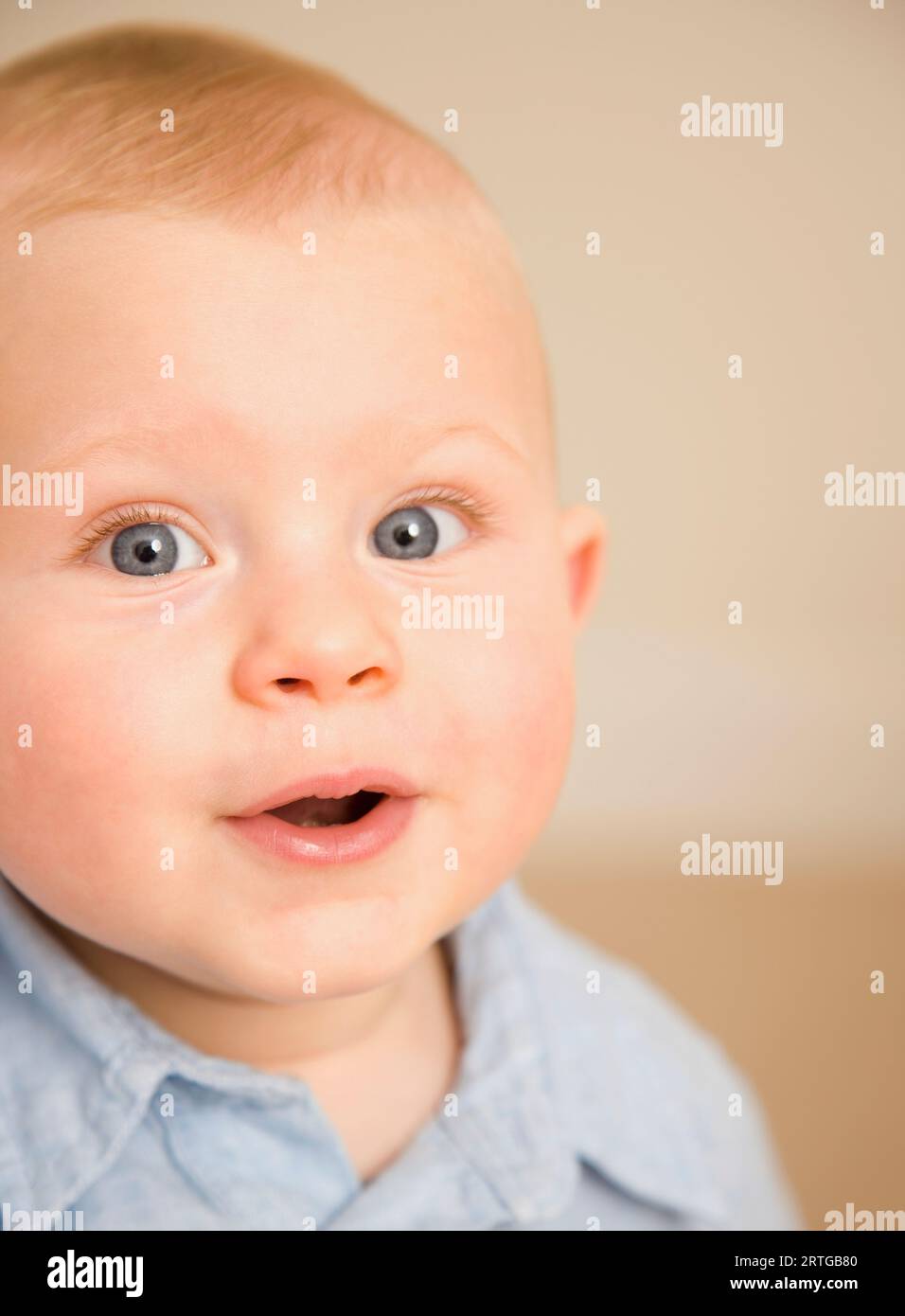 Close up of cute baby boy with mouth open Stock Photo - Alamy