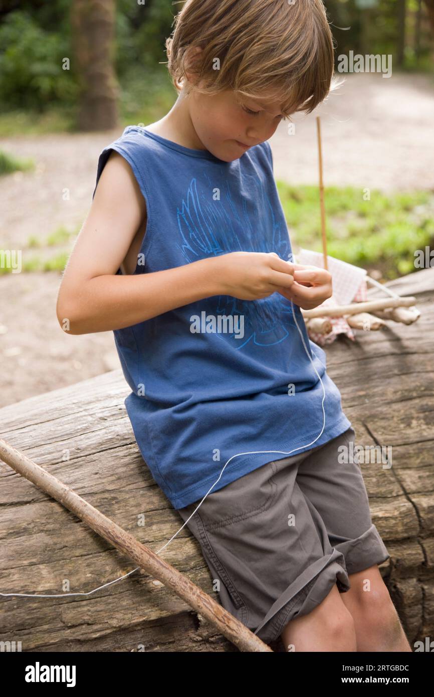 Boy tying knot hi-res stock photography and images - Alamy