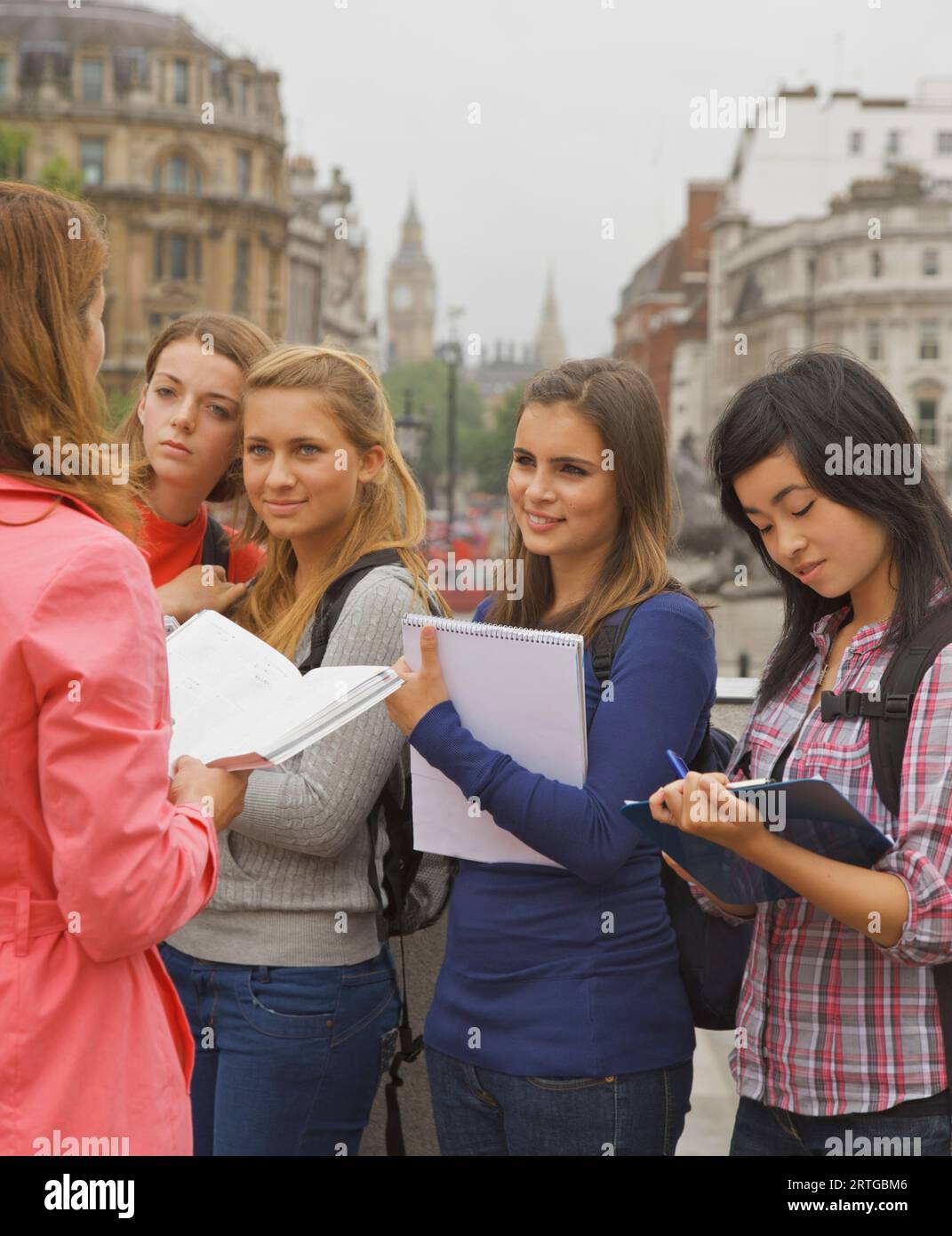 Back View of Woman Standing in front of Teenage Girls Stock Photo - Alamy