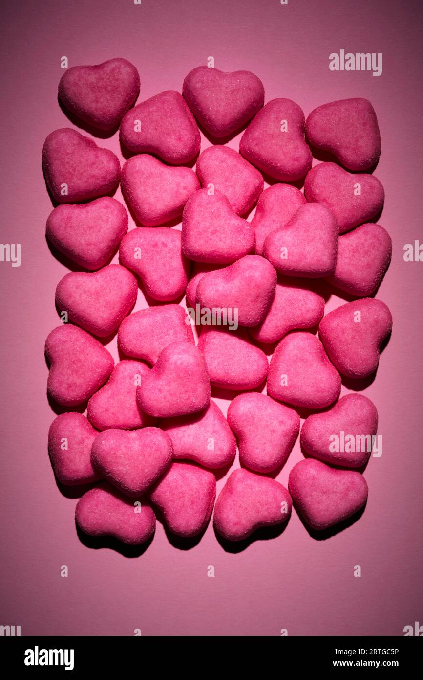 Still life pink heart candy on pink background Stock Photo - Alamy