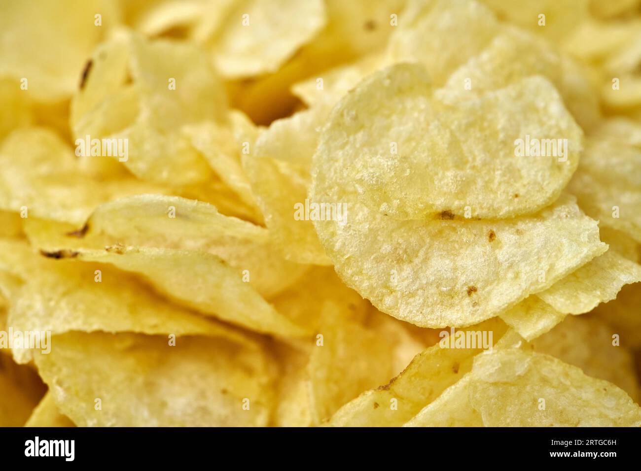 Extreme close up yellow potato chips Stock Photo - Alamy