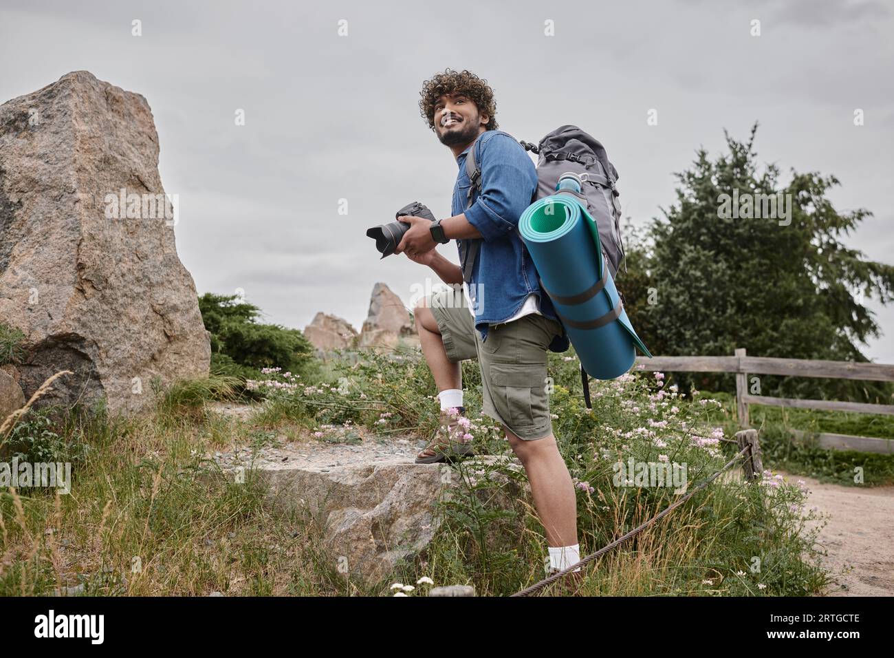 travel and photography concept, happy indian backpacker using digital ...