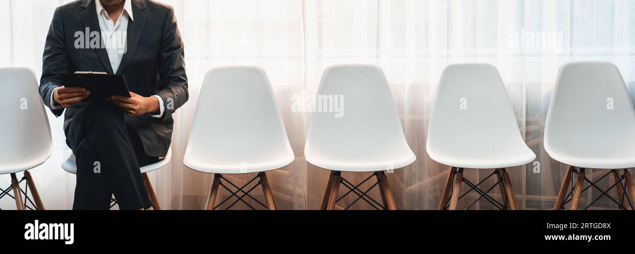 Job applicant waiting for interview in waiting room alone with empty ...