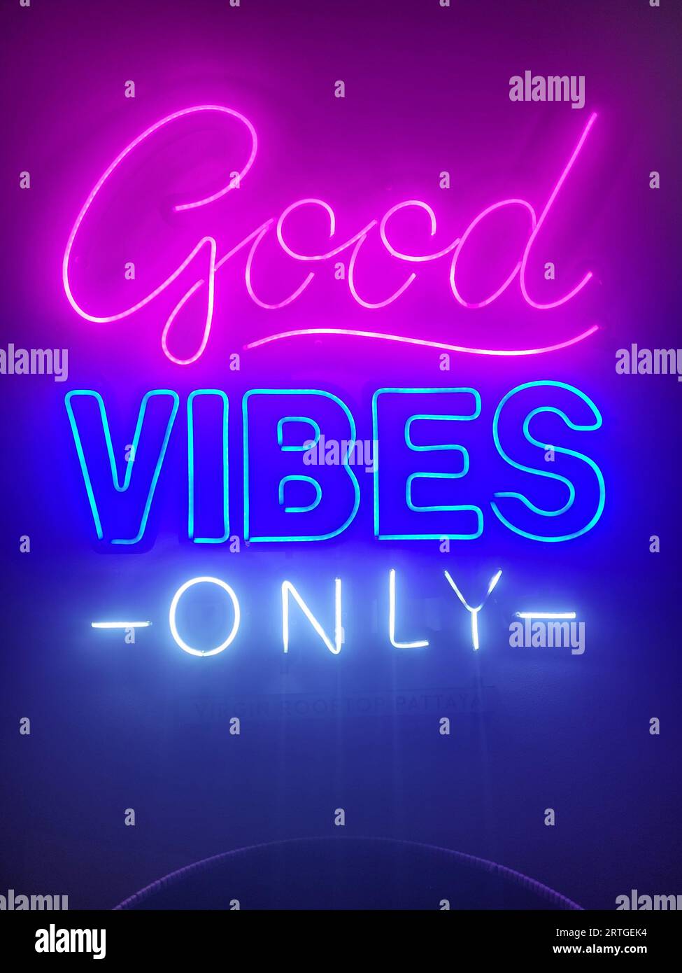 A vibrant neon sign featuring the phrase 'Good Vibes Only' in a ...