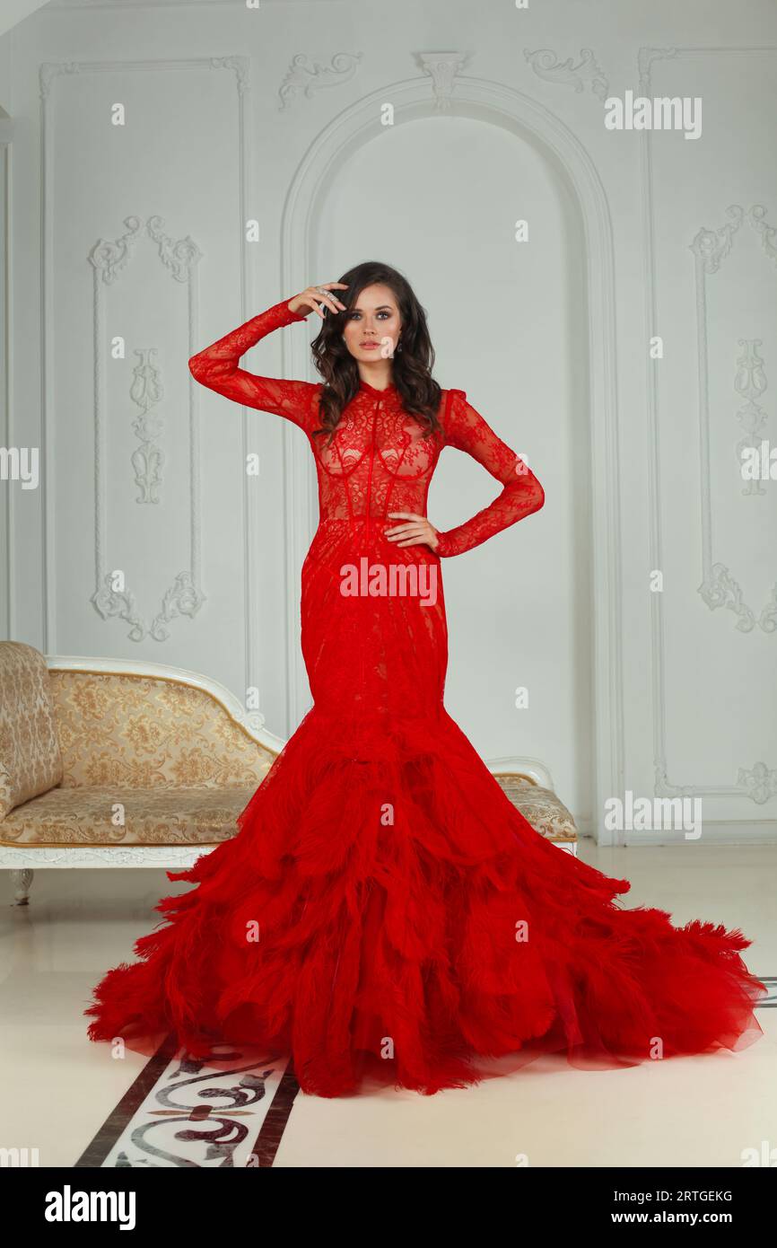 Elegant perfect model woman in red evening gown. Nice sensual lady with perfect makeup and ...