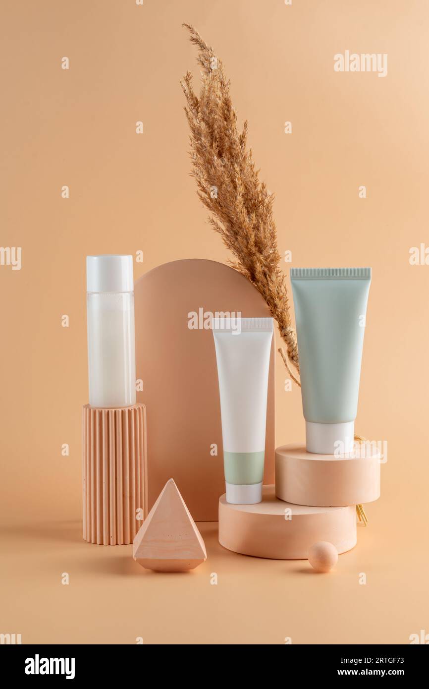 Group of white and green blank, unbranded cosmetic cream jars and tubes ...