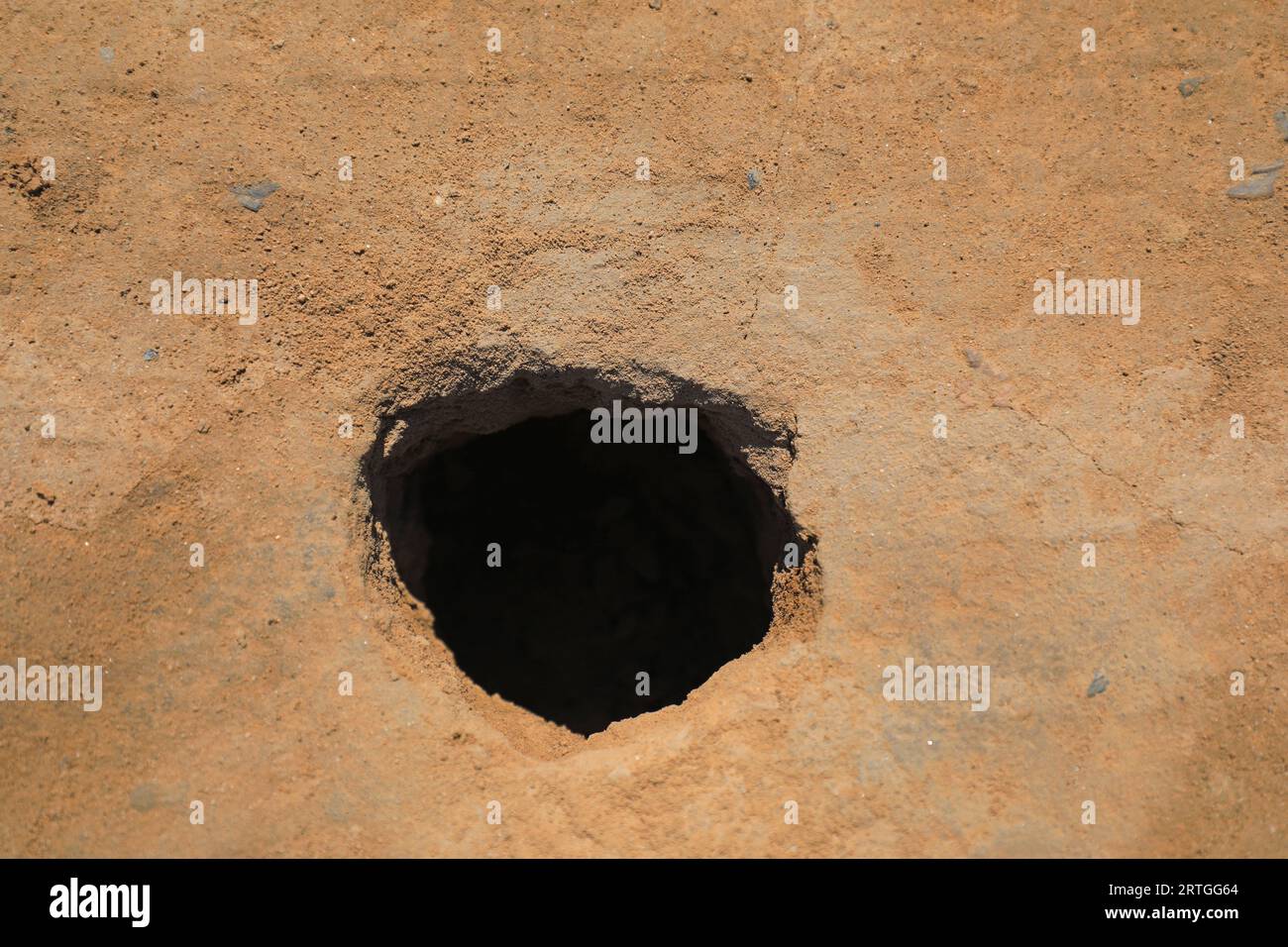 Hole in the ground, close-up photo Stock Photo - Alamy
