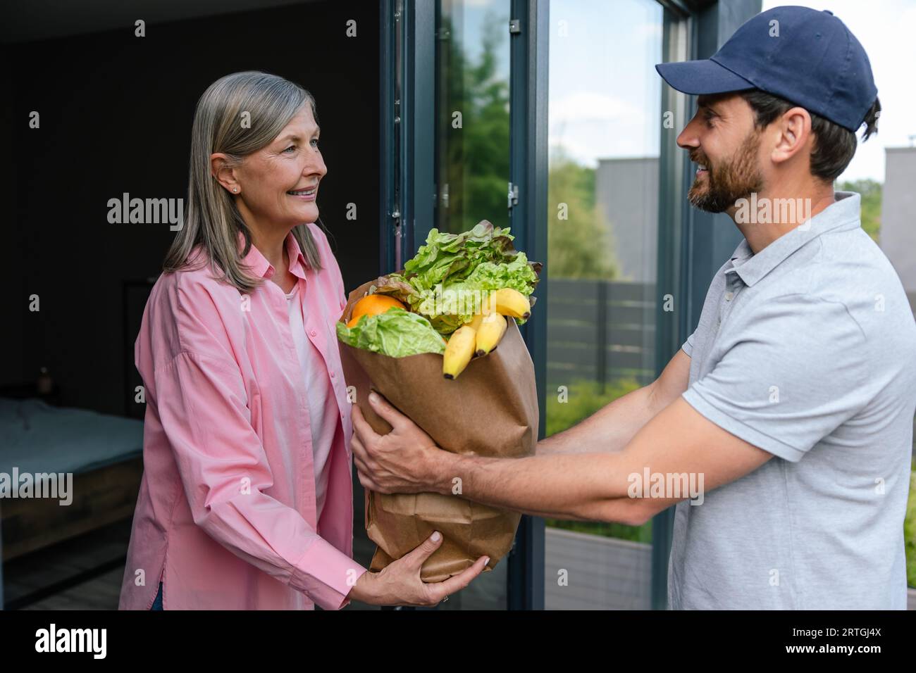 Middle aged man holding grocery bag hi-res stock photography and images ...