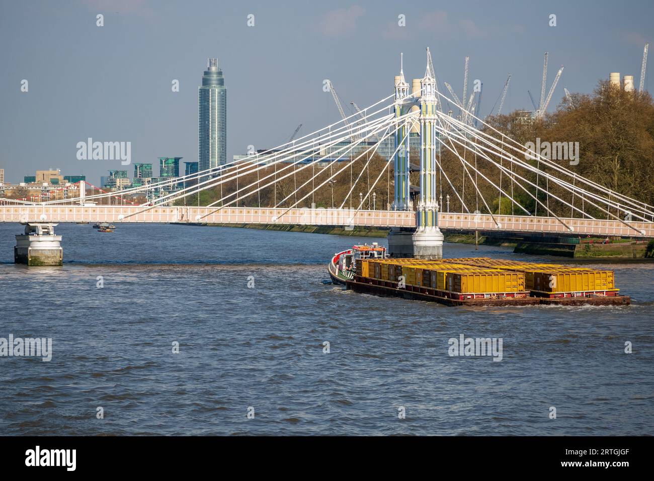 Barges towed by a tugboat on the River Thames at Albert Bridge Stock ...