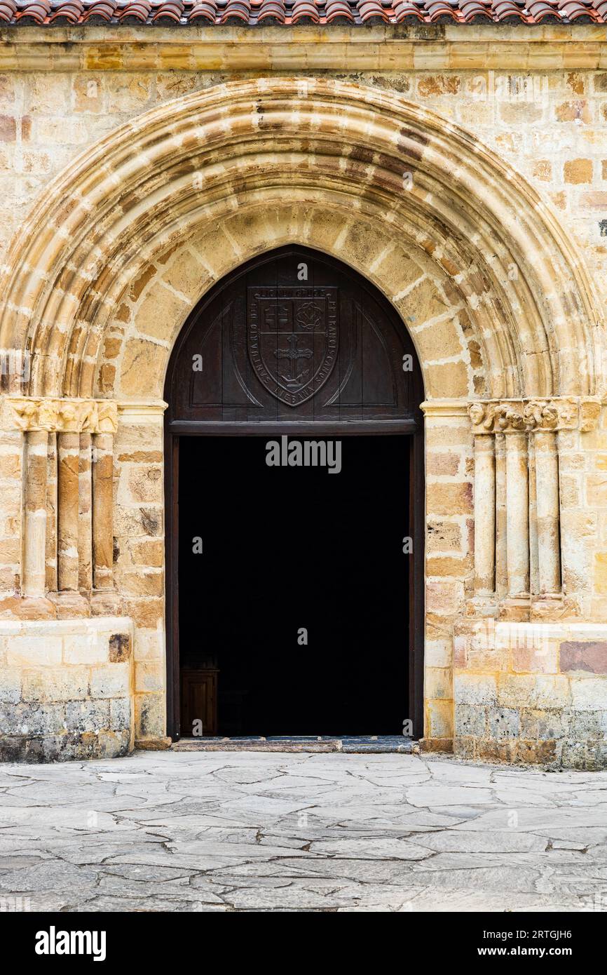 Ornate doorway with traditional wooden door and multiple stone arches ...