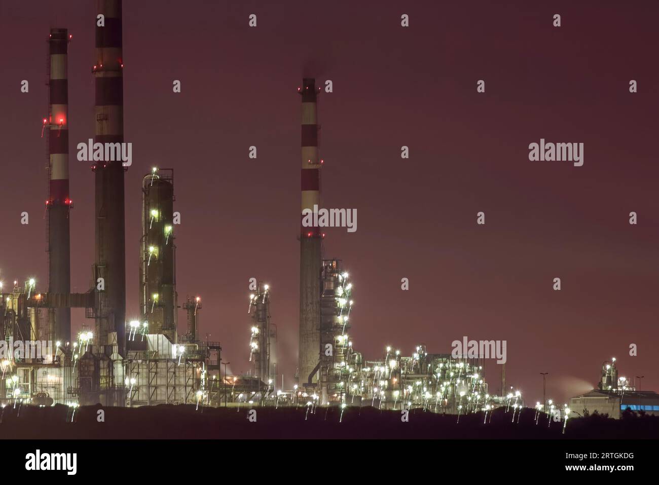 Old oil refinery by night Stock Photo - Alamy