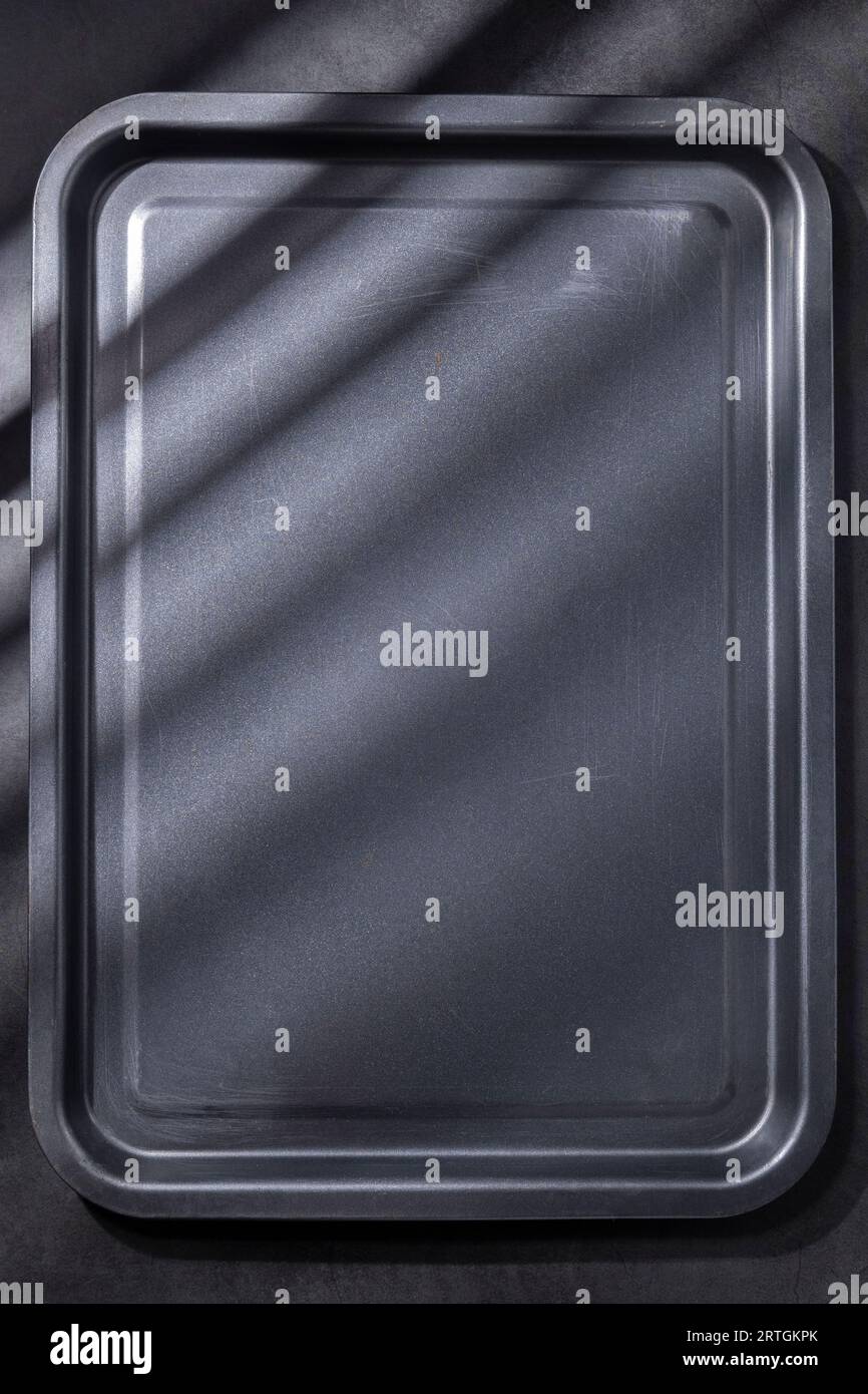 Empty gray tray on the table, kitchen utensils Stock Photo - Alamy