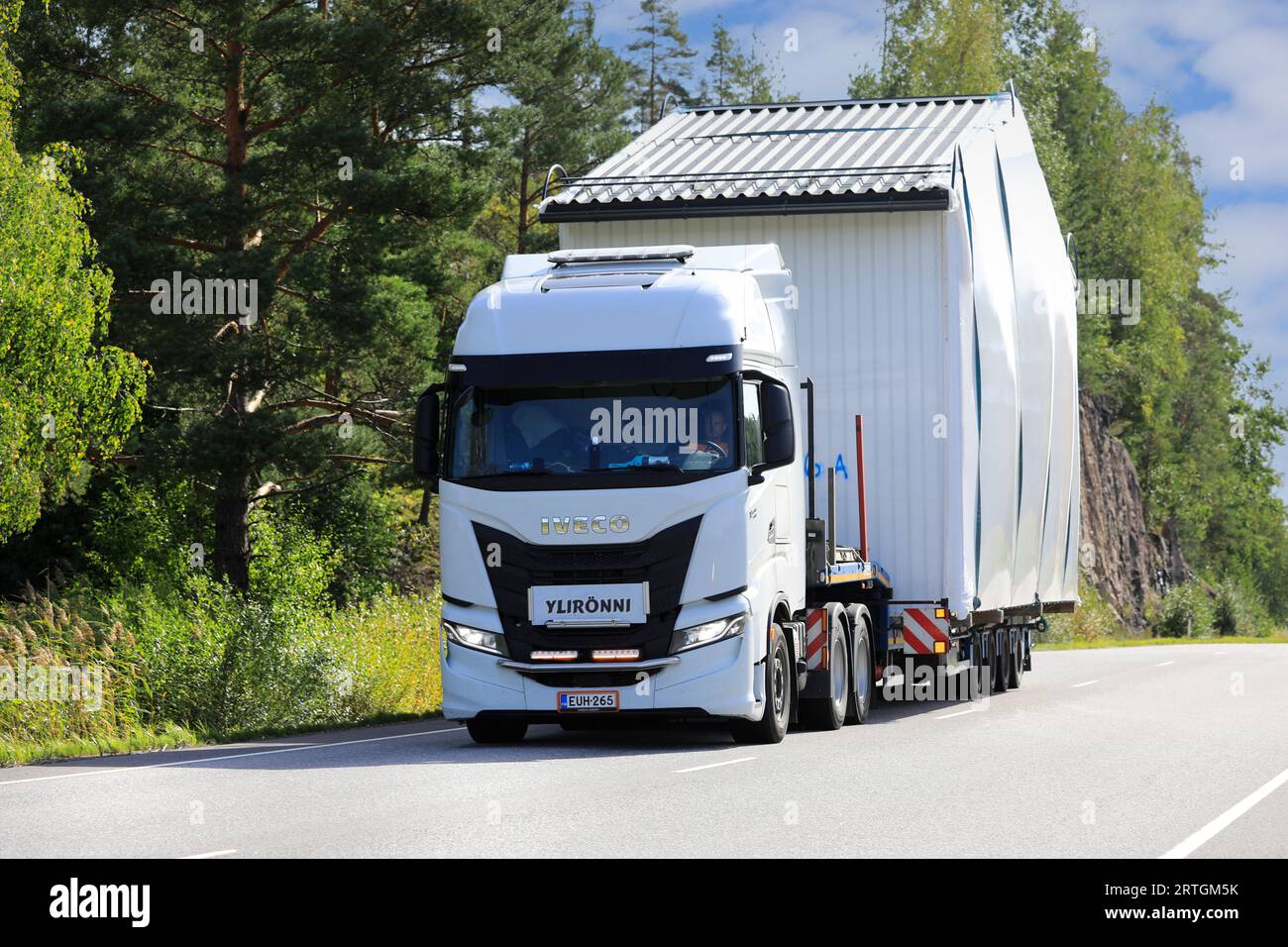 Exceptional load transport of a prefabricated cabin pulled by white ...