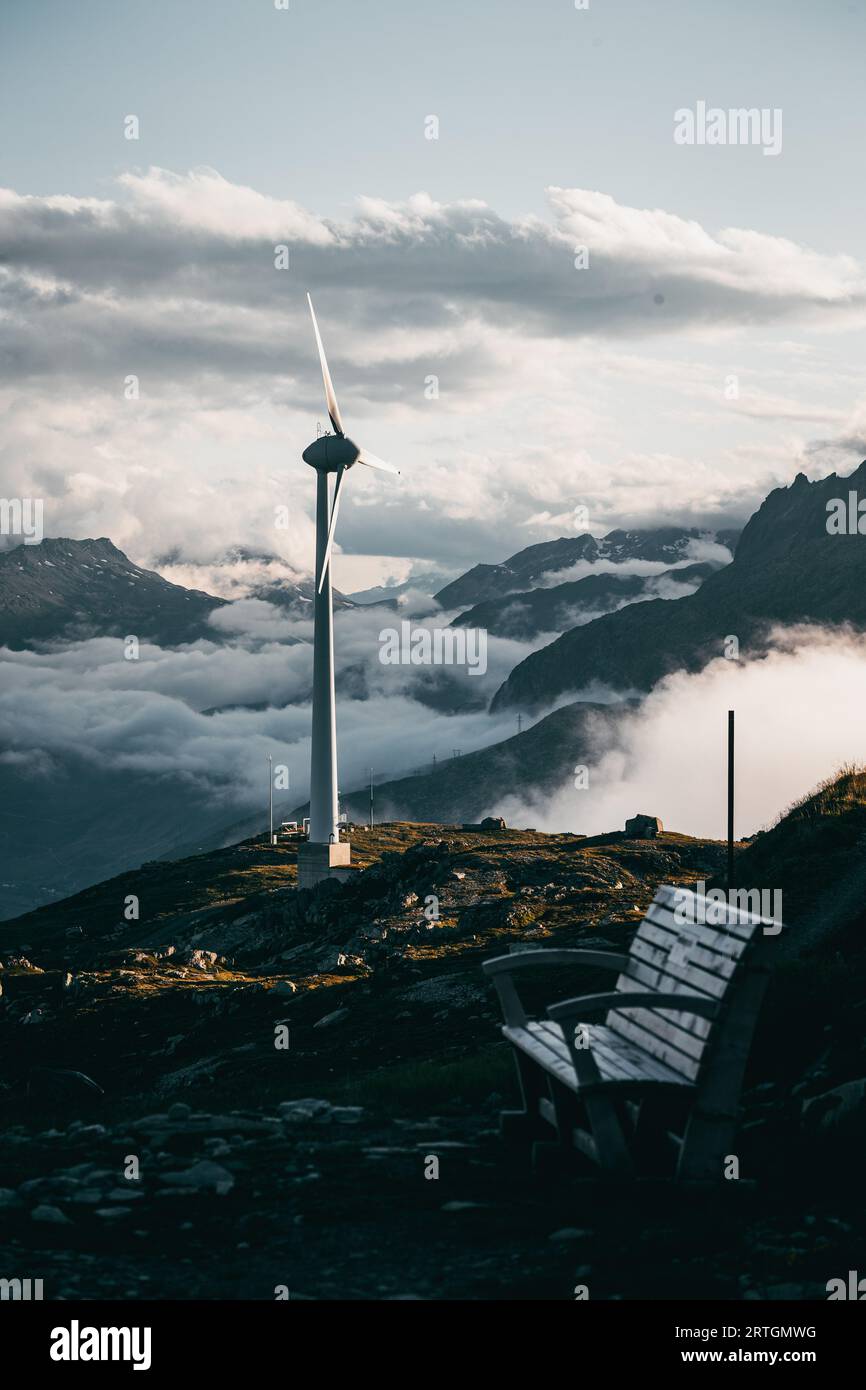 A wind turbine in the Swiss Alps over clouds Stock Photo - Alamy