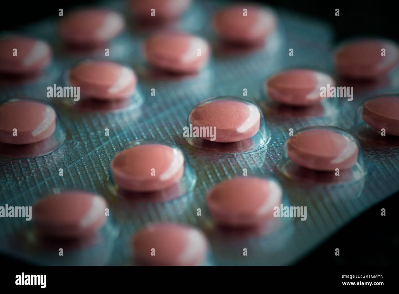 Extreme close-up of tablet strip with select focus on a single tablet ...