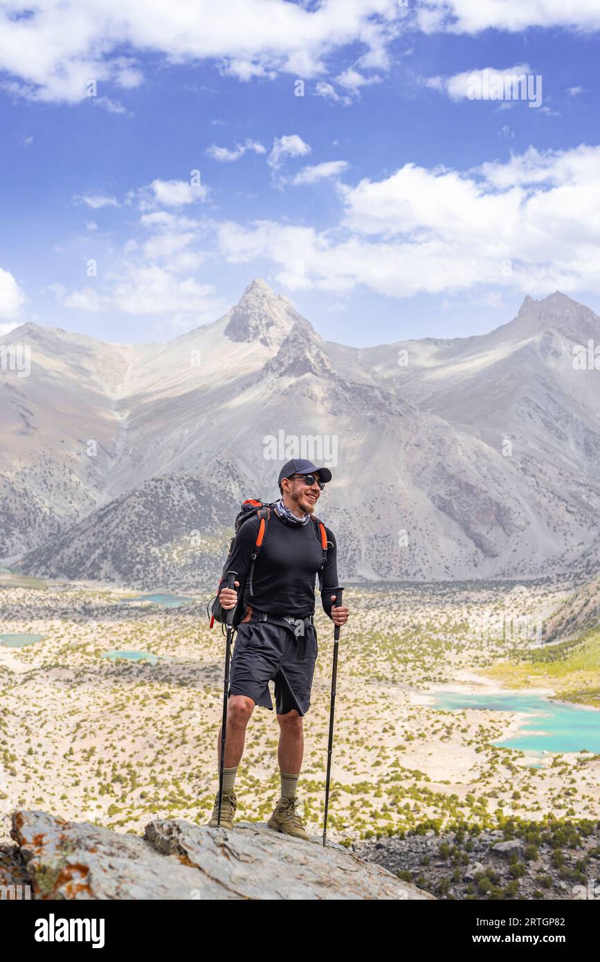 Man hiker exploring mountains lake in Tajikistan Stock Photo - Alamy