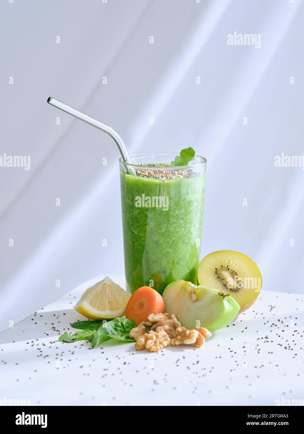 Glass filled with healthy green smoothie served on table with various ...