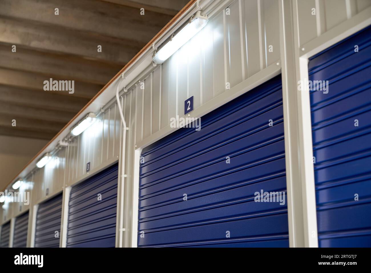 From below of numbers below locked automatic blue roller shutters of ...