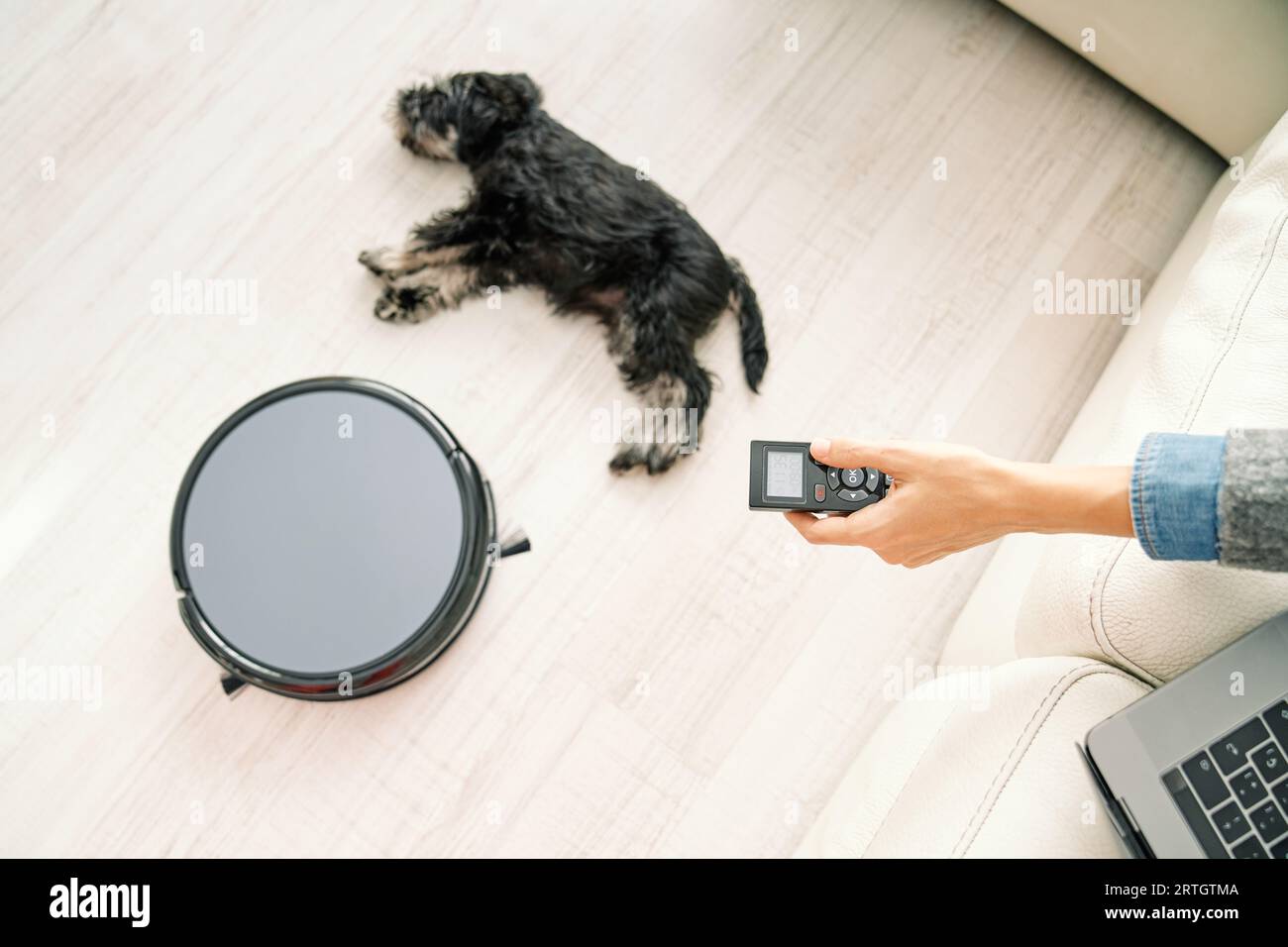 From above of crop unrecognizable person using remote control while ...