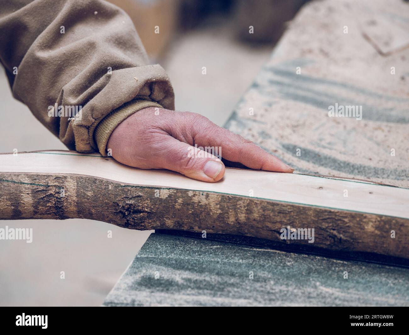 Crop faceless professional male carpenter with wooden piece standing at ...