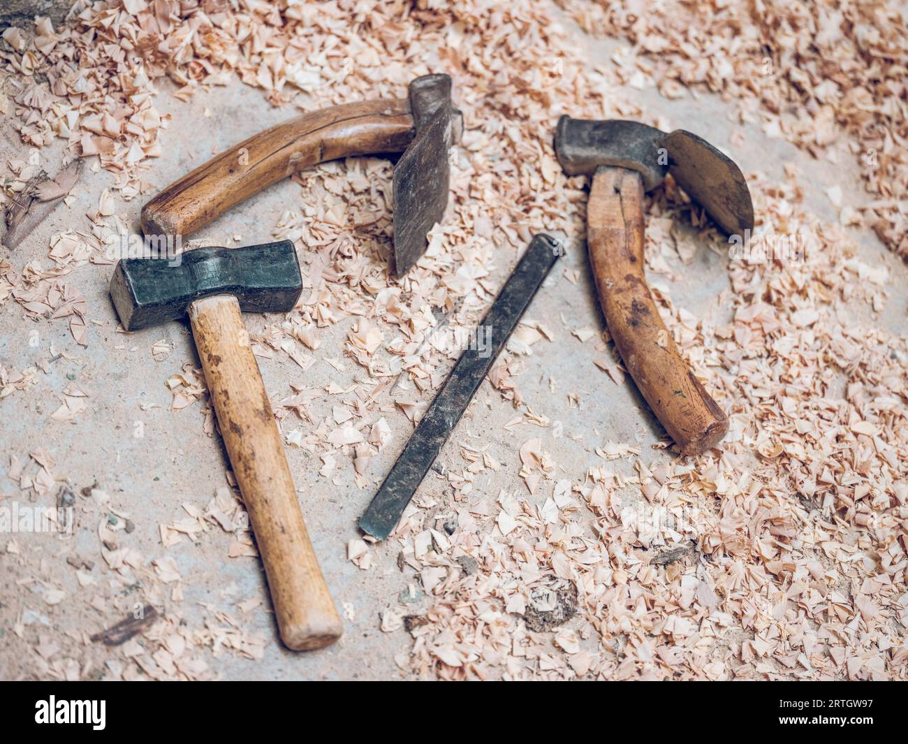 Top view set of ancient adze tools and hammer placed on messy surface ...