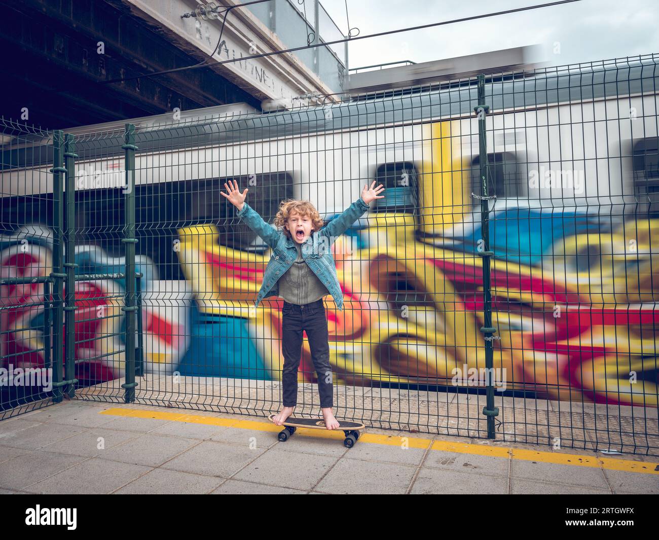 Full body of excited preteen boy in denim jacket standing barefoot on ...