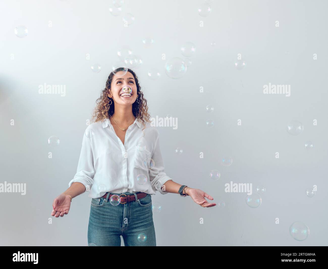 Cheerful female expressing glee and looking with astonishment at ...