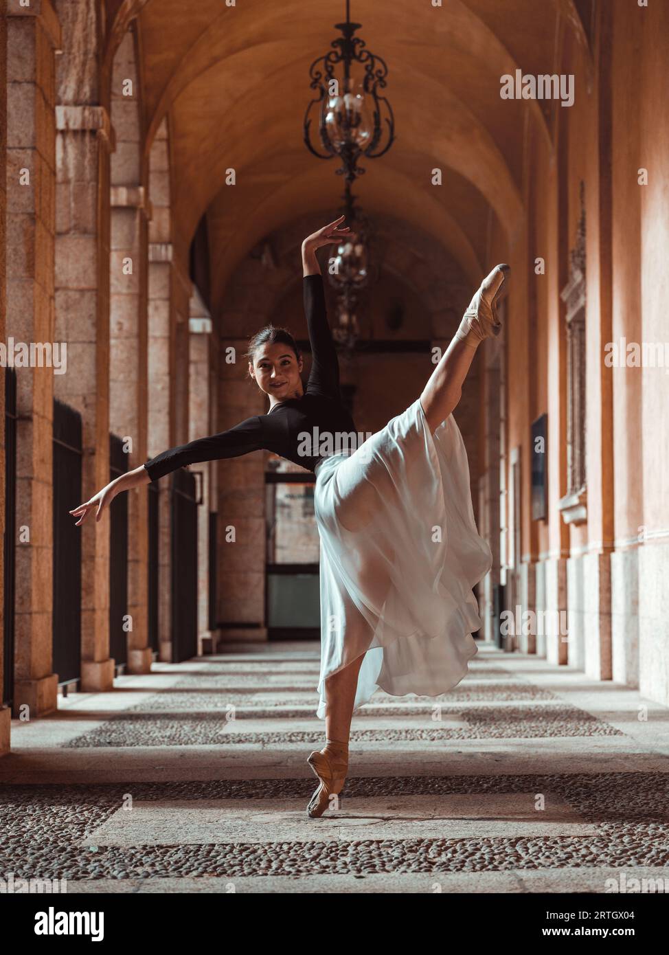 Full body of gracious ballerina in pointe shoes performing ballet ...