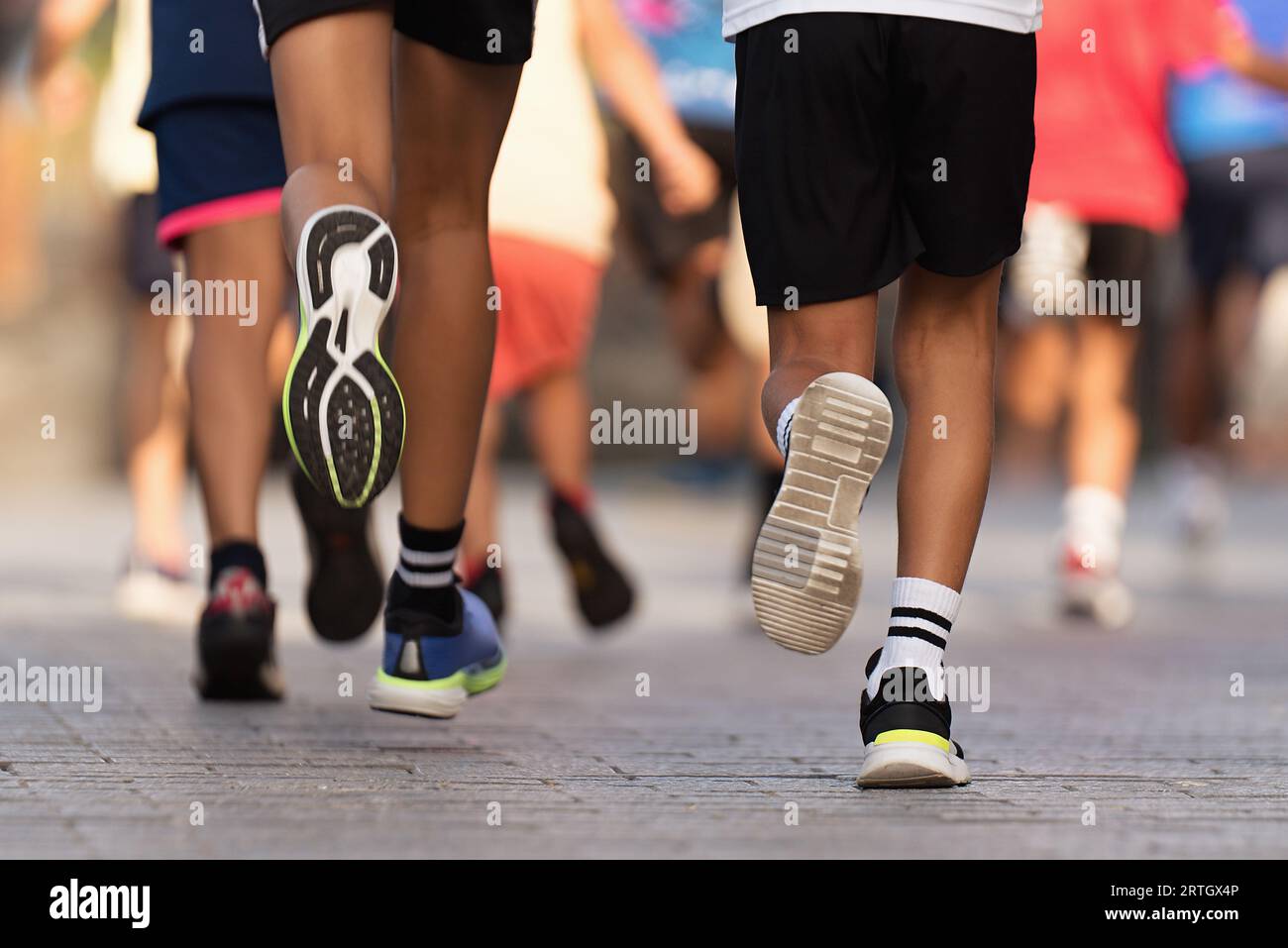 Running children, young athletes run in a kids run race, running on ...