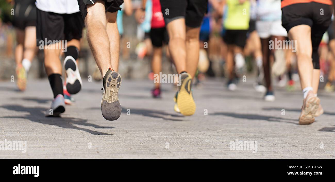 Marathon runners running on city road, large group of runners Stock ...