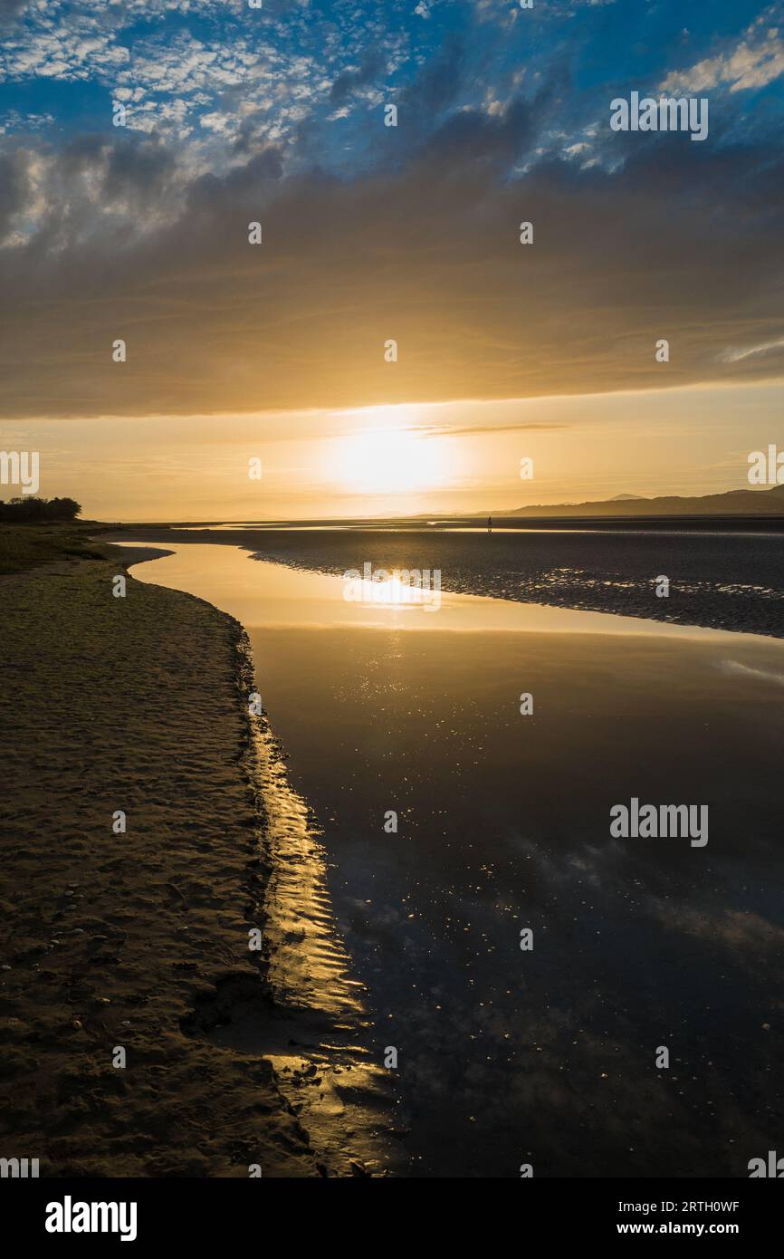 Sunset at Traeth Bach with blue sky and calm sea Stock Photo - Alamy