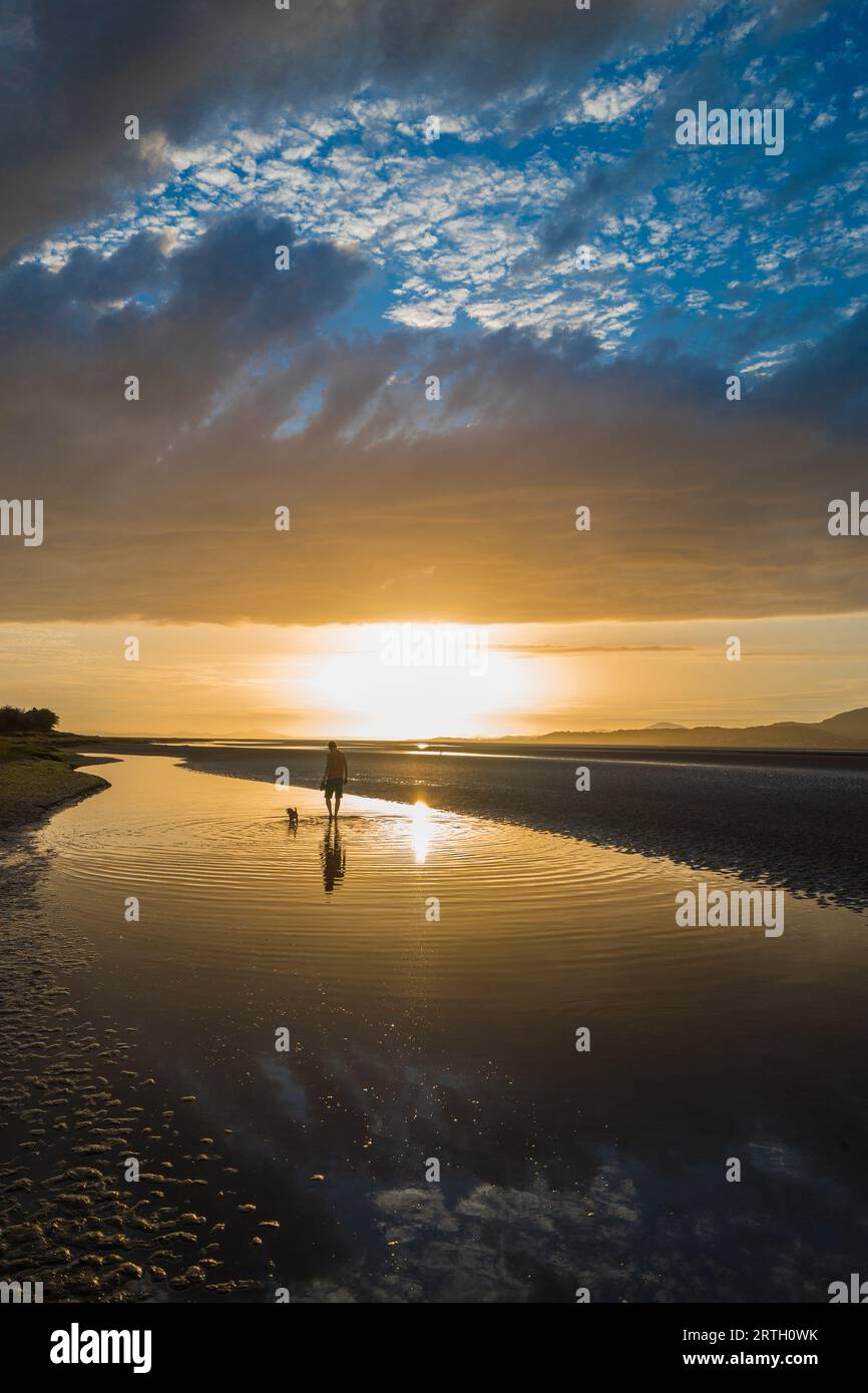 Sunset at Traeth Bach with blue sky and calm sea Stock Photo - Alamy
