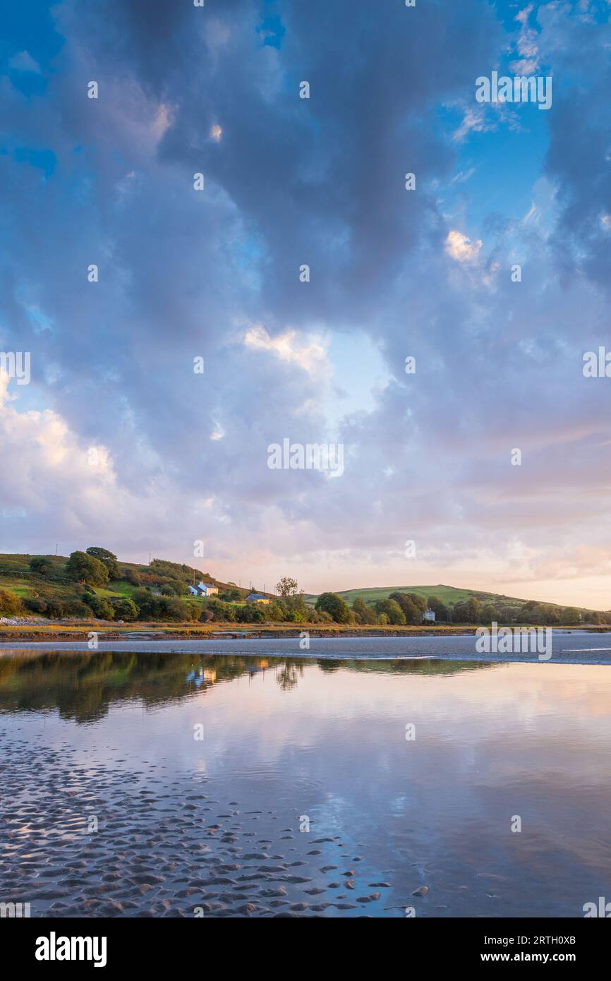 Sunset at Traeth Bach with blue sky and calm sea Stock Photo - Alamy